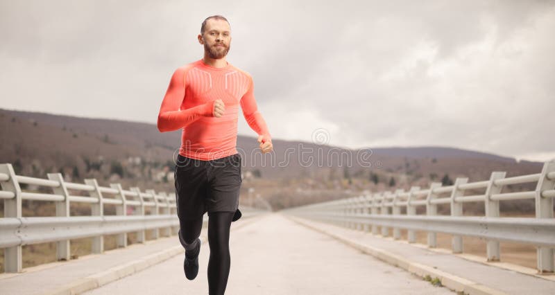 Bearded Guy in Sportswear Running Across a Bridge Stock Image - Image ...
