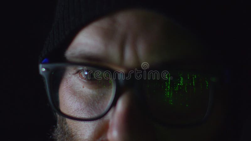 Bearded Hacker in Eyeglasses Working on Computer in the Night Green Programming Code Reflecting ...