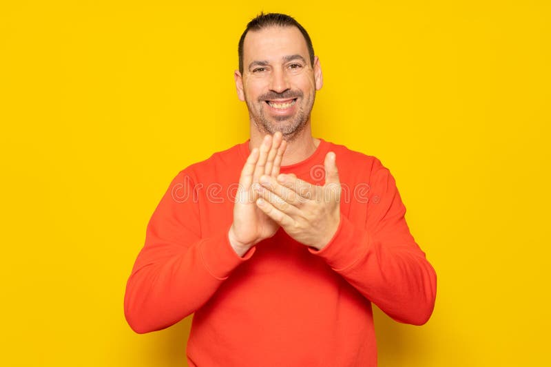 Bearded Hispanic Man In His 40s Wearing A Red Jumper Clapping Hands