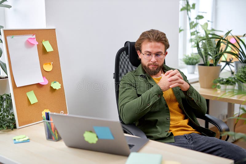 Bearded Male Working Alone in Office, Using Laptop. Handsome Guy Sit ...