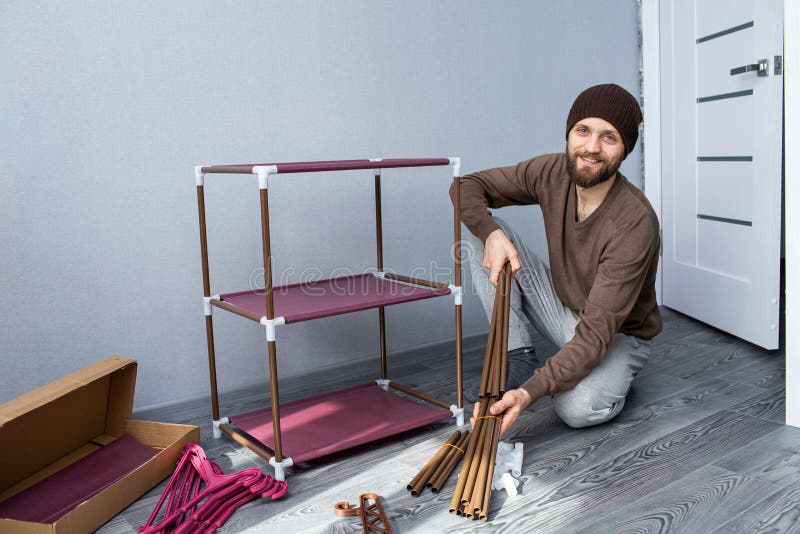 Bearded Man Assembles a Shelf for the Rack. Stock Image - Image of ...