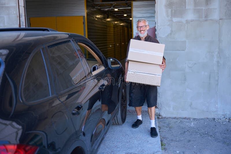 Bearded Man Carries Boxes from a Car Stock Photo - Image of unload ...