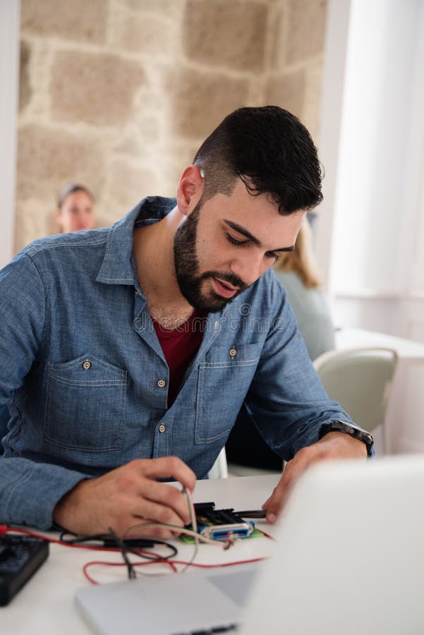 Bearded Man at a Desk Working on Electronics Stock Image - Image of ...