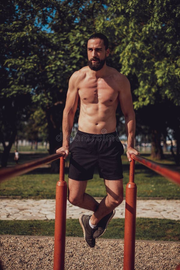Bearded Man Doing Dips on the Outdoor Bars Stock Image - Image of ...