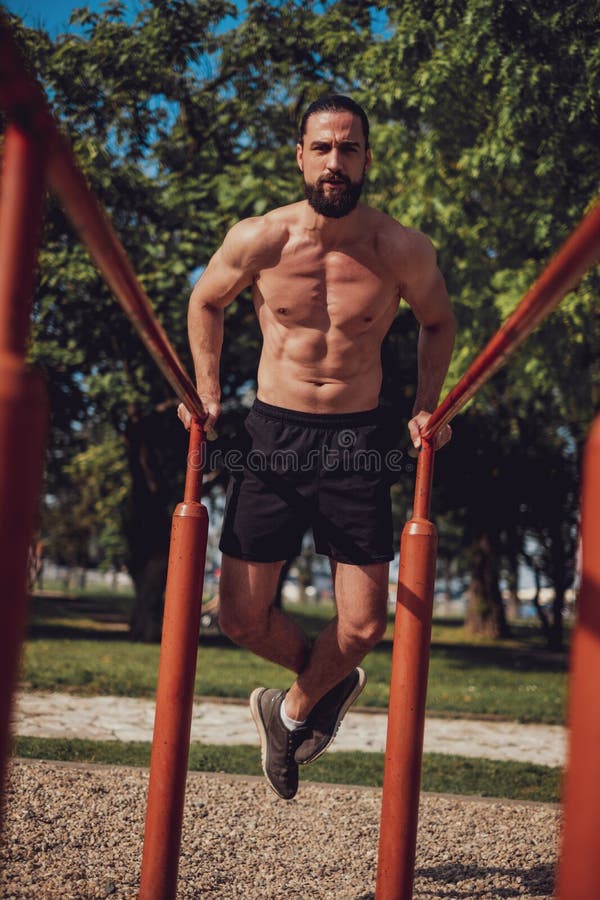 Bearded Man Doing Dips and Looking in To the Camera Stock Photo - Image ...