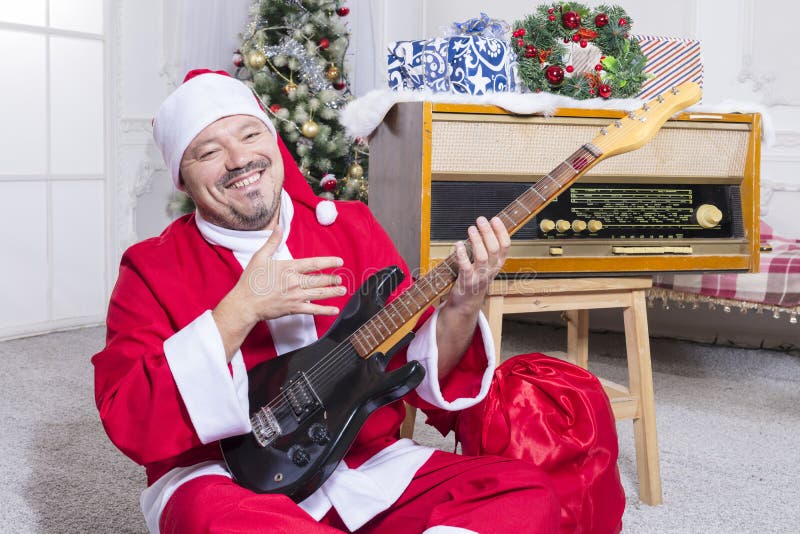 Bearded Man Dressed in Santa Claus Costume Playing Guitar Stock Image ...