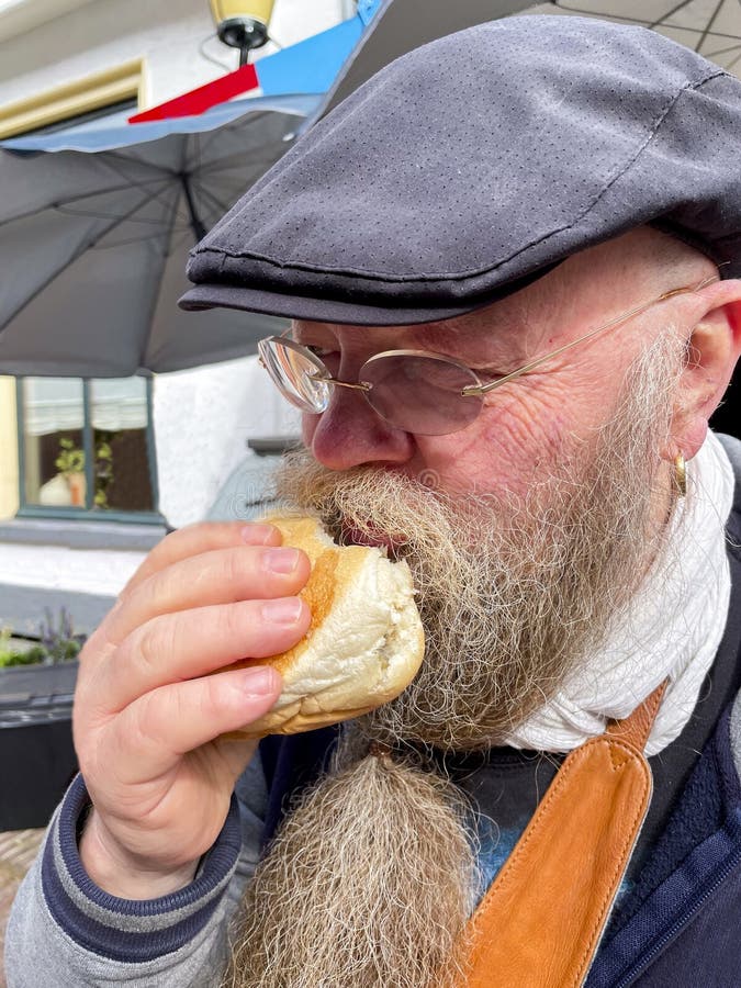 Bearded Man Enjoying a Fish Roll with Herring Stock Image - Image of ...