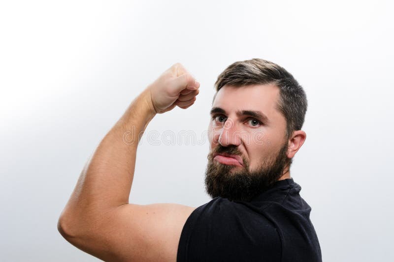 Man Flexing Bicep, Showing Strength and Determination. Stock Photo ...