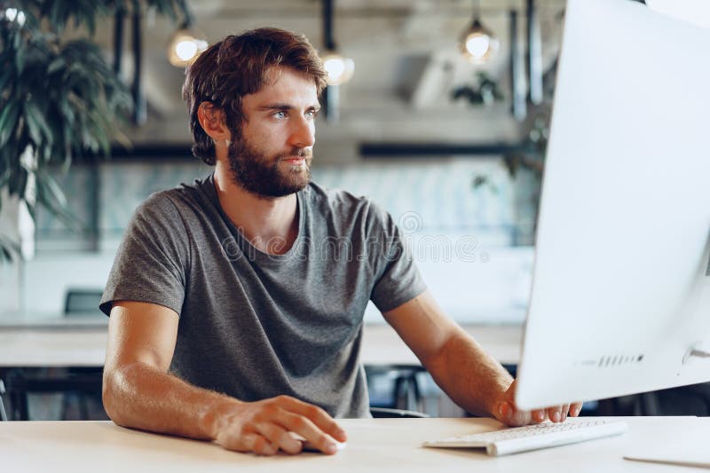 Bearded Man Freelancer Using Computer in a Modern Coworking Place Stock ...