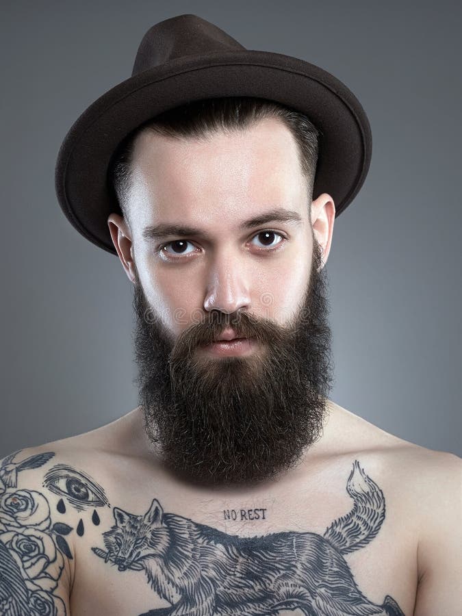 Bearded Man in Hat. Boy with Tattoo Stock Photo - Image of mustache ...