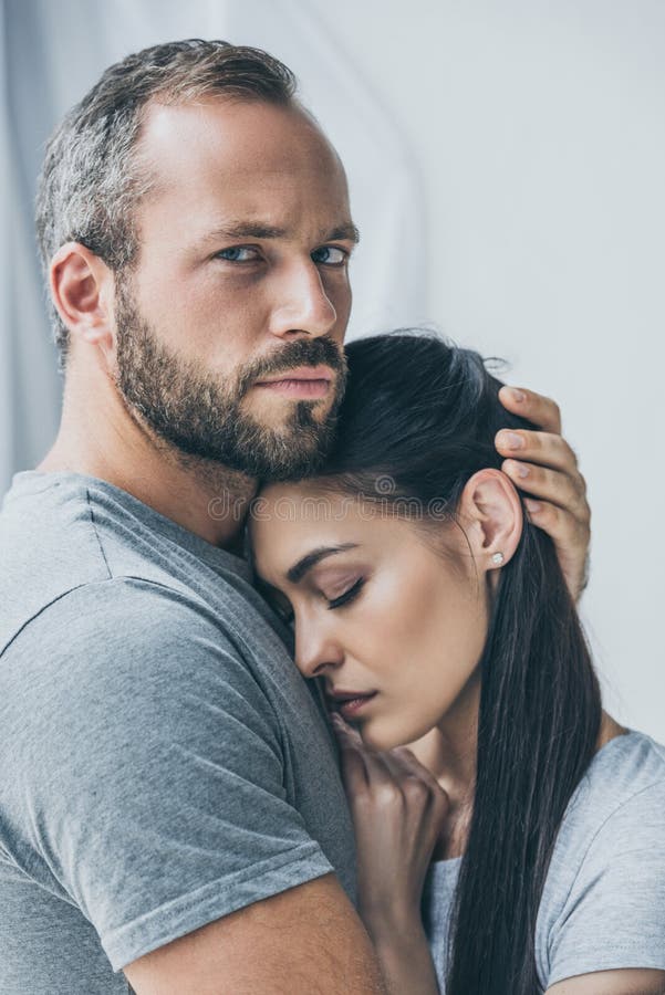 Bearded Man Hugging Upset Girlfriend and Looking Stock Photo - Image of ...