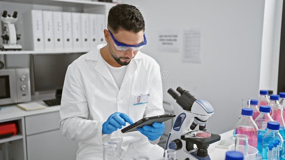 Bearded Man in Lab Coat Using Tablet in a Modern Laboratory with ...