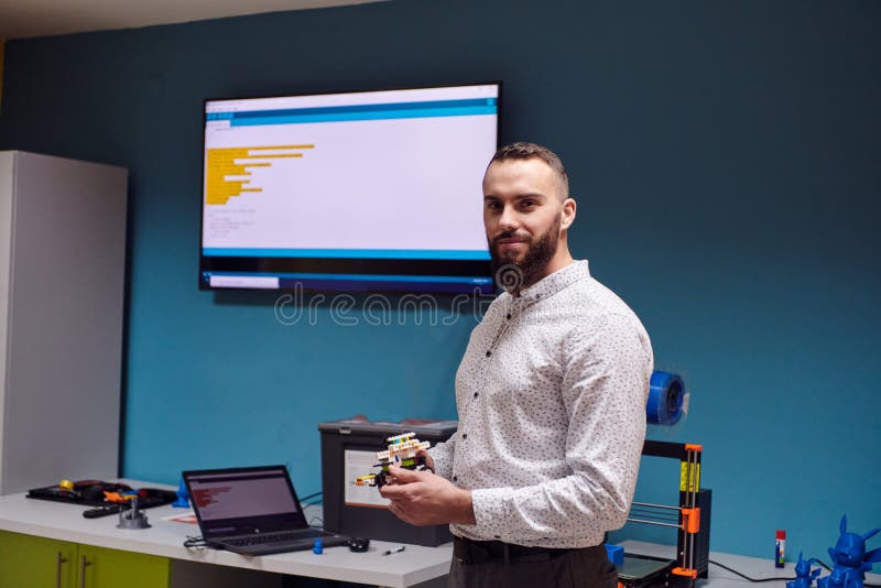 A Bearded Man in a Modern Robotics Laboratory, Immersed in Research and ...