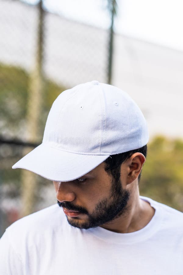 A Bearded Man Proudly Displays His White Blank Cap Hat, Adding an Air ...