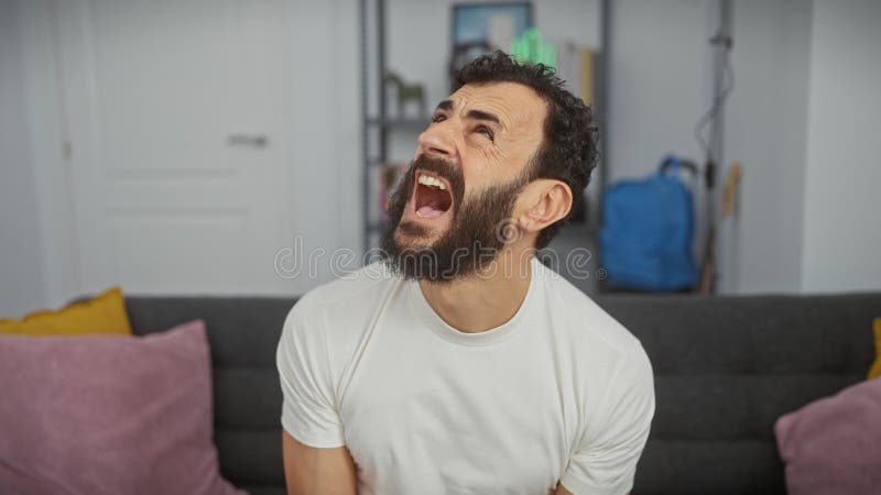 Bearded Man Screaming in a Living Room with a Sofa Stock Image - Image ...