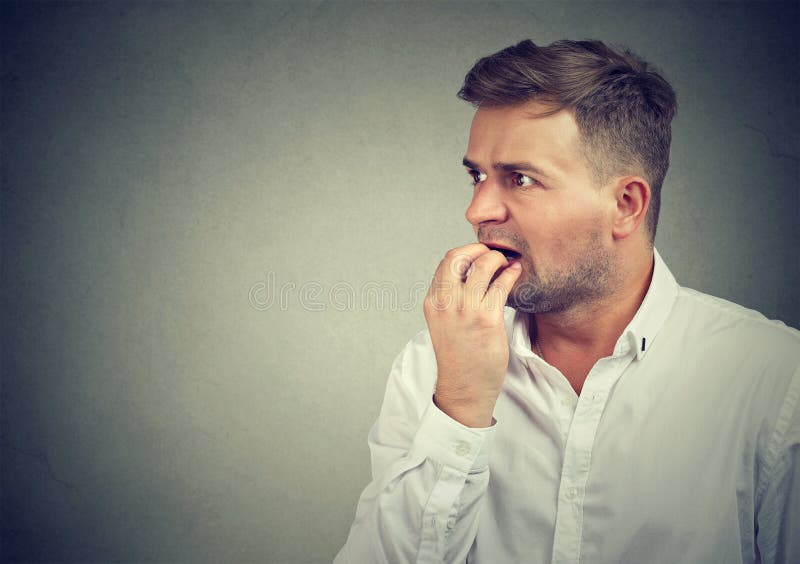 Man in panic biting nails stock photo. Image of fear - 114490068
