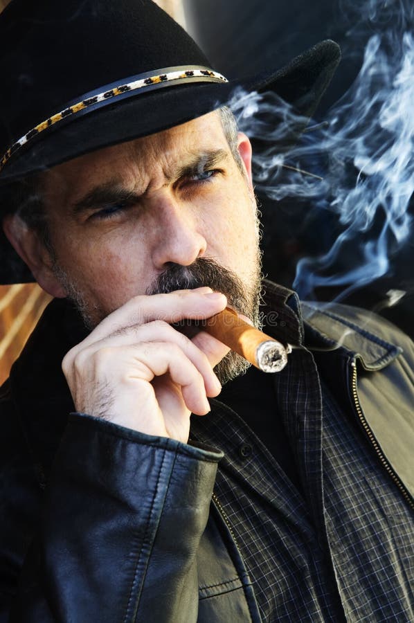 Bearded man smoking cigar stock image. Image of male - 10929509