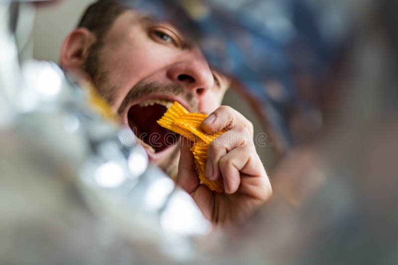A Bearded Man Takes Chips from the Package, Photo from the Package ...