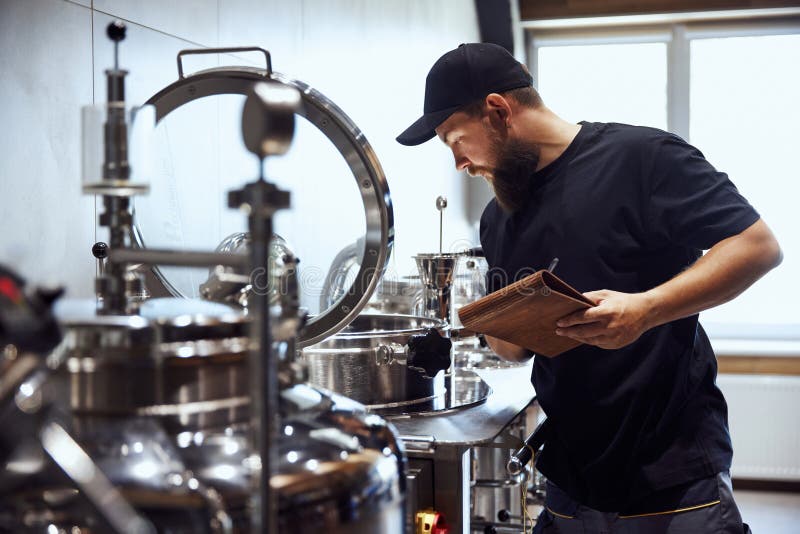 Bearded Man, Technologist Checking Brewing Tools, Making Notes ...