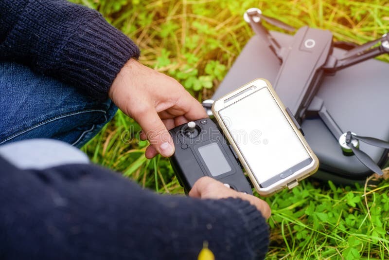 Man Using a Drone with Remote Controller Making Photos and Videos ...