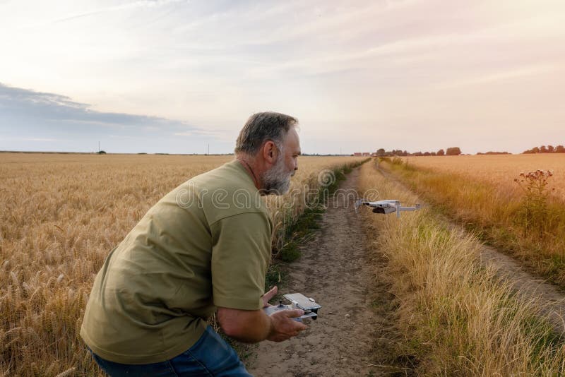Man Using Drone with Remote Controller Making Photos and Videos, Having ...