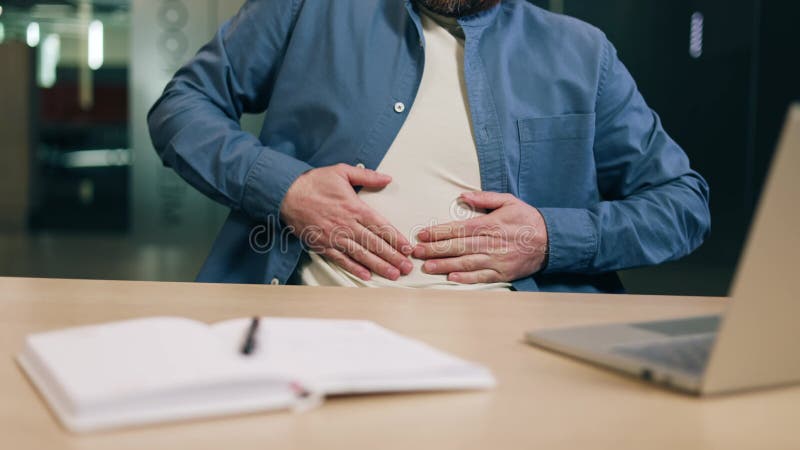 Bearded Man Working by Computer while Getting Interrupted by Abdominal ...