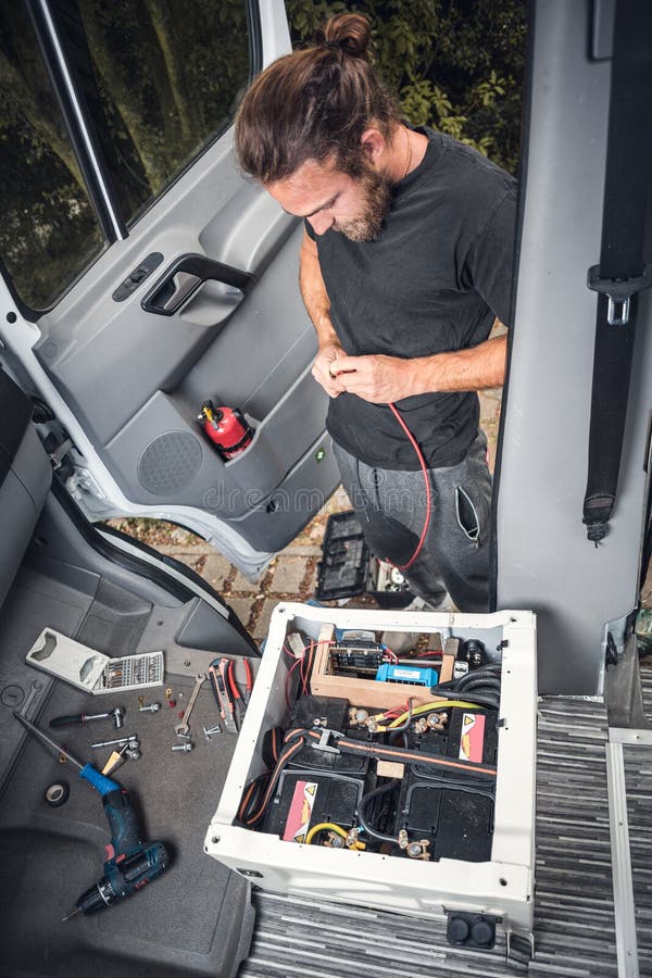 Man Installing Electronics in His DIY Camper Van Stock Image - Image of ...