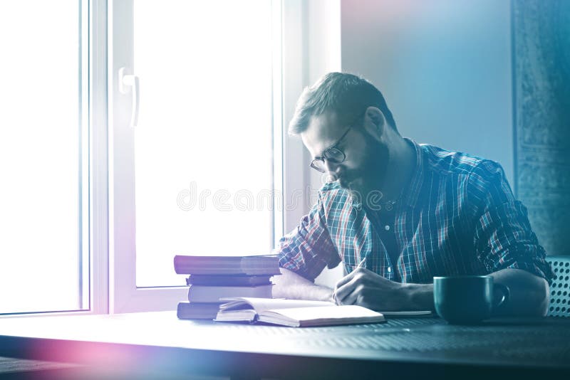 Man Writing with Pen and Reading Books Stock Image - Image of ...
