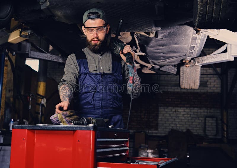 Mechanic Holds Angle Grinder on a Shoulder. Stock Image - Image of ...