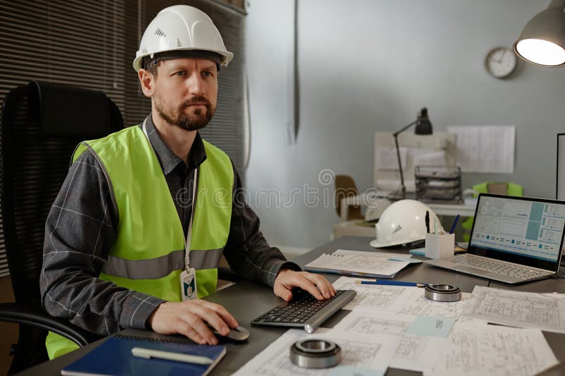 Bearded Mechanical Engineer Wearing Hardhat Using Computer at Workplace ...