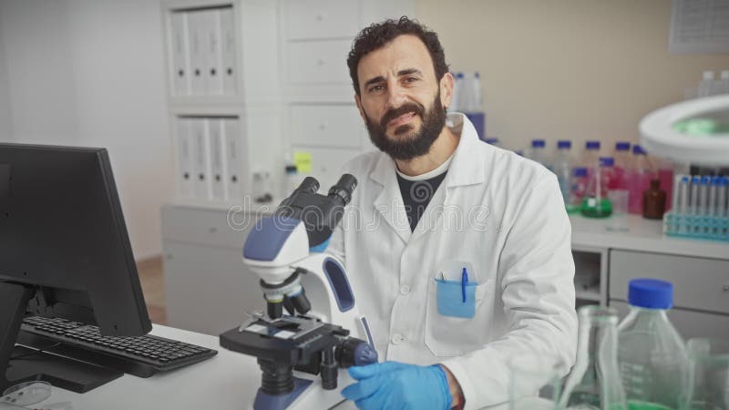 Bearded Scientist Examining Specimens Under Microscope in Modern ...