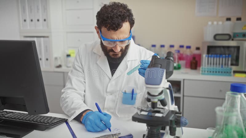 Bearded Scientist in Lab Coat Examines Sample with Microscope in ...