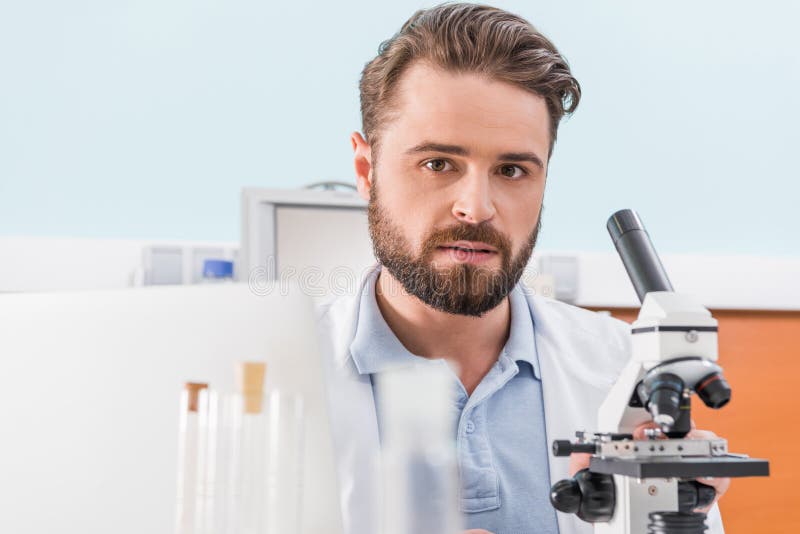 Bearded Scientist Working with Microscope in Laboratory Stock Image ...