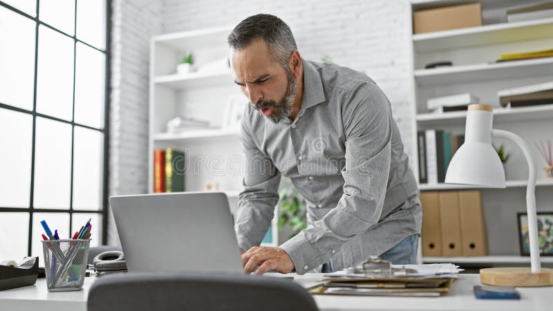Bearded Senior Hispanic Man Working Focused in a Modern Office Setting ...