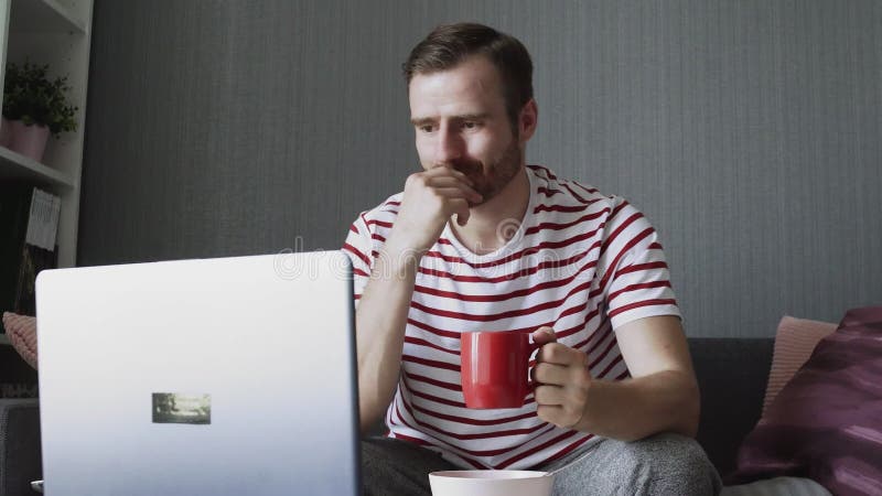 Bearded Smiling Man Drinking Tea and Scrolling Computer. Stock Footage ...
