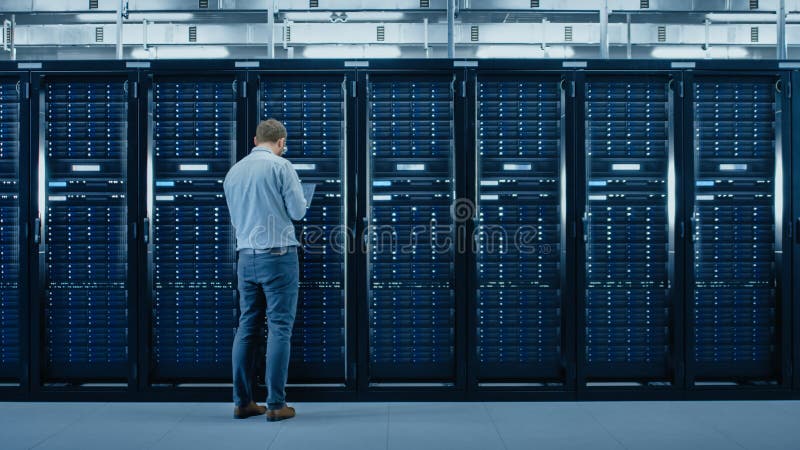 Data Center Engineer in High Visibility Vest Using Laptop Computer ...