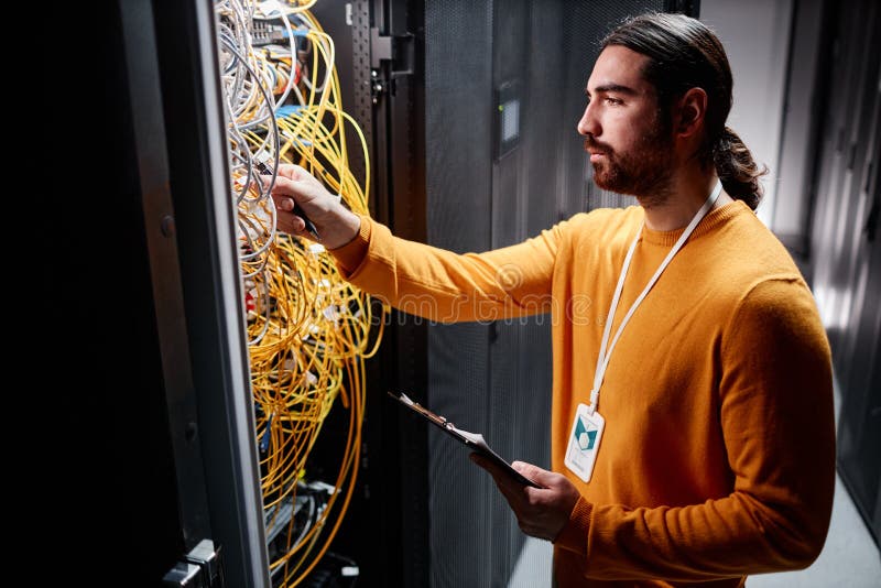 Bearded Technician Working with Server Network and Connecting Cables ...