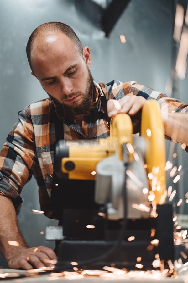 Bearded Worker Using Electrical Grinding Machine in Service Station ...
