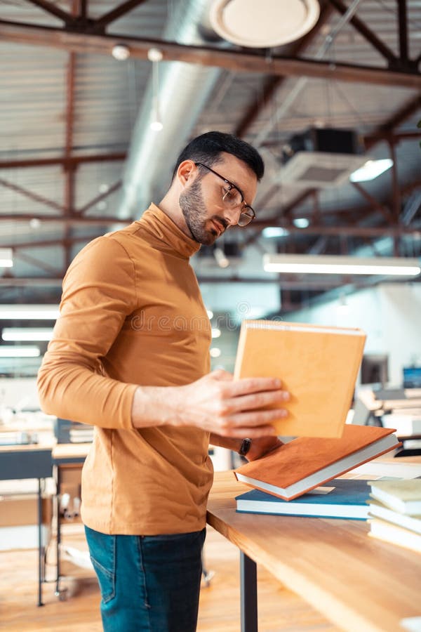 Bearded Writer Looking at the Samples of Book Covers Stock Photo ...