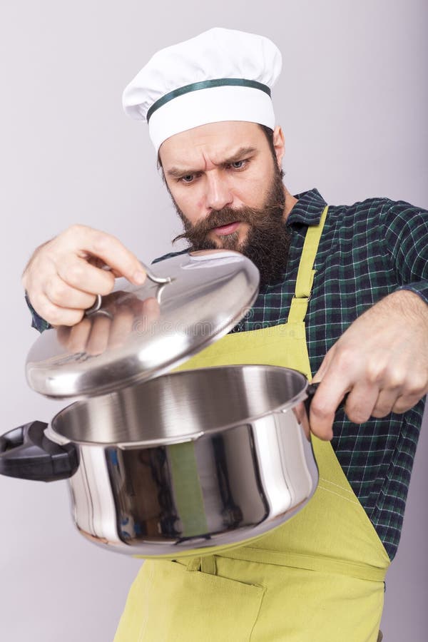 Bearded Young Chef Looking into the Pot with an Expression of D Stock ...