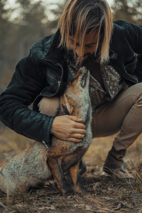 Young man with a wild fox stock image. Image of japan - 176825097