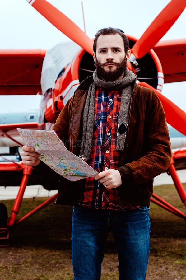 A Bearded Young Pilot, a Traveler Stands on the Background of a Red Old ...