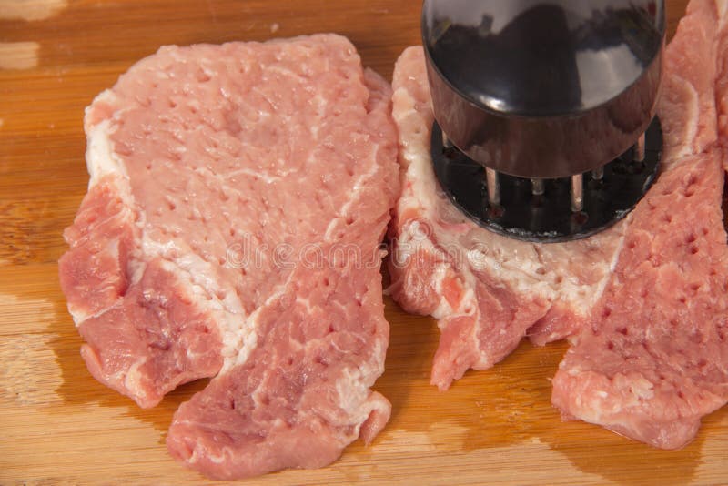 Beat the Meat on a Wooden Board on a White Background Stock Photo ...