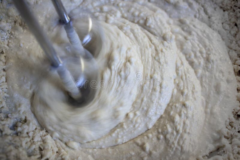 Beaters of Electric Mixer Beating Lumpy Batter in a Bowl - Closeup and ...