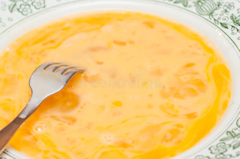 Beating Eggs in a White Plate with a Fork. Cooking Morning Omelet Stock ...