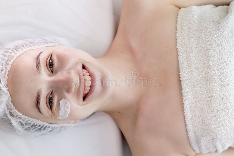 A Beautician Applied A Drop Of Cream To A Young Womanand X27 S Face Skin