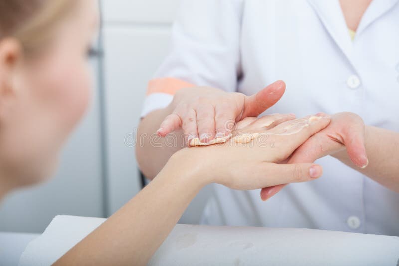 Beautician Applying Moisturizing Cream on Client Hands. Beauty Salon ...
