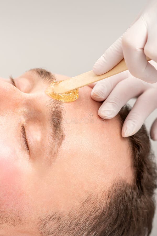 Beautician Applying Wax Paste between Eyebrows during the Procedure of ...