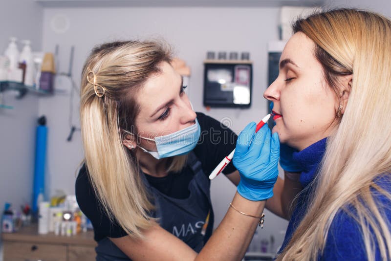The Beautician Prepares the Lips for Permanent Makeup, the Model Looks ...