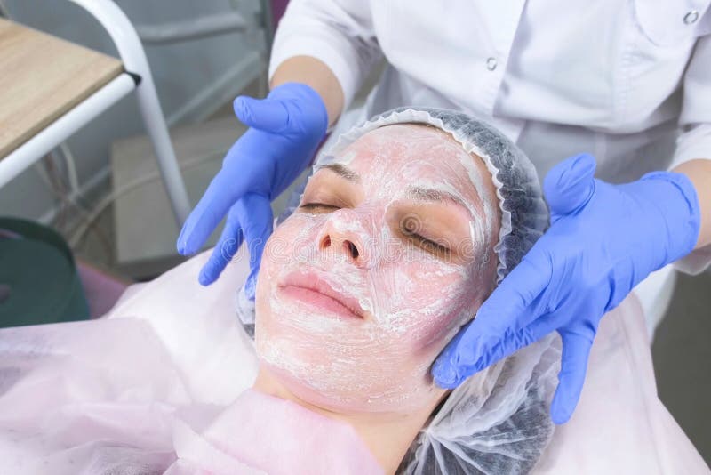 Beautician Rolls The Mask On The Woman`s Face Massage Movements
